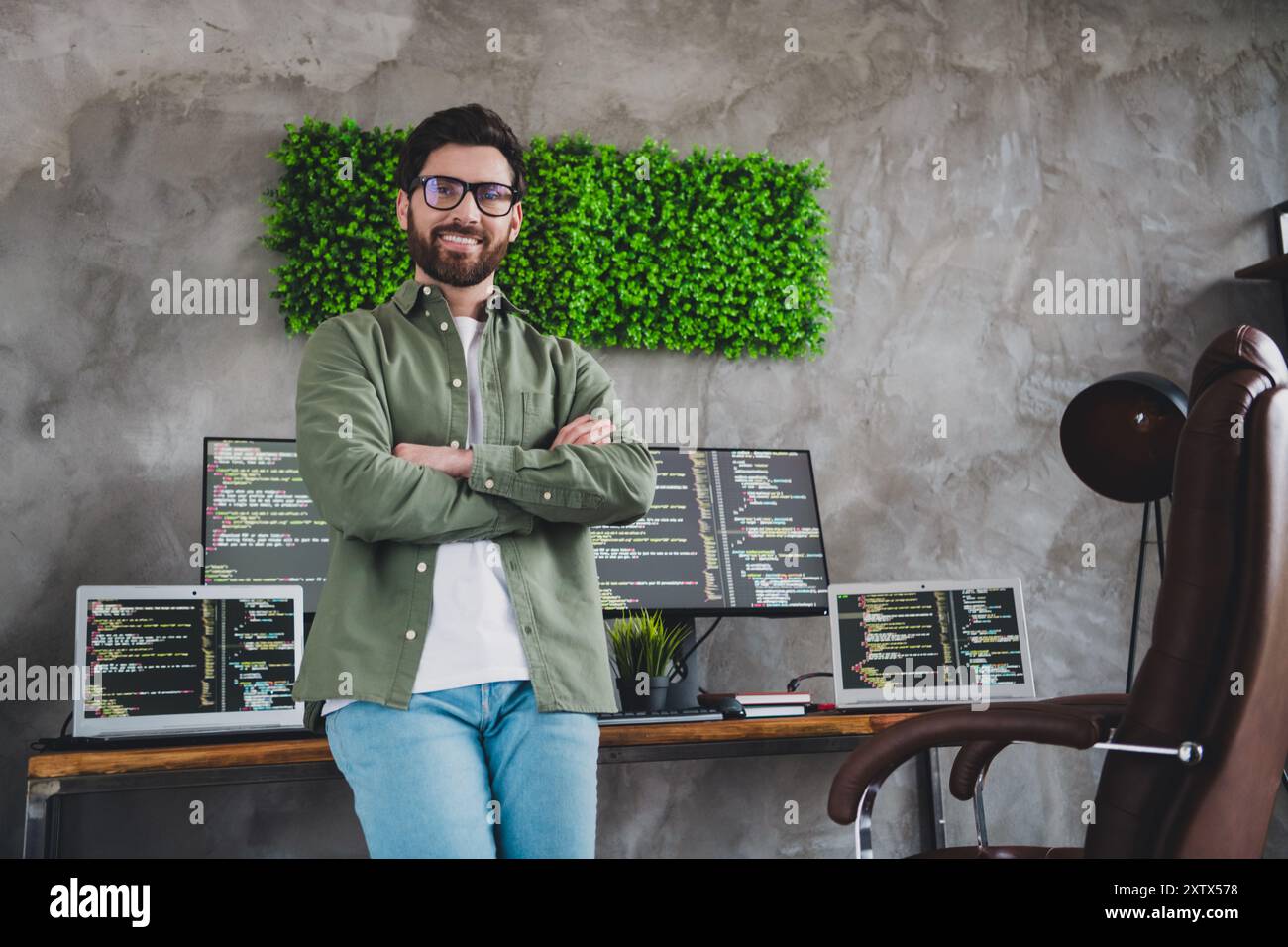Portrait of professional hacker young man crossed arms computer desk ...