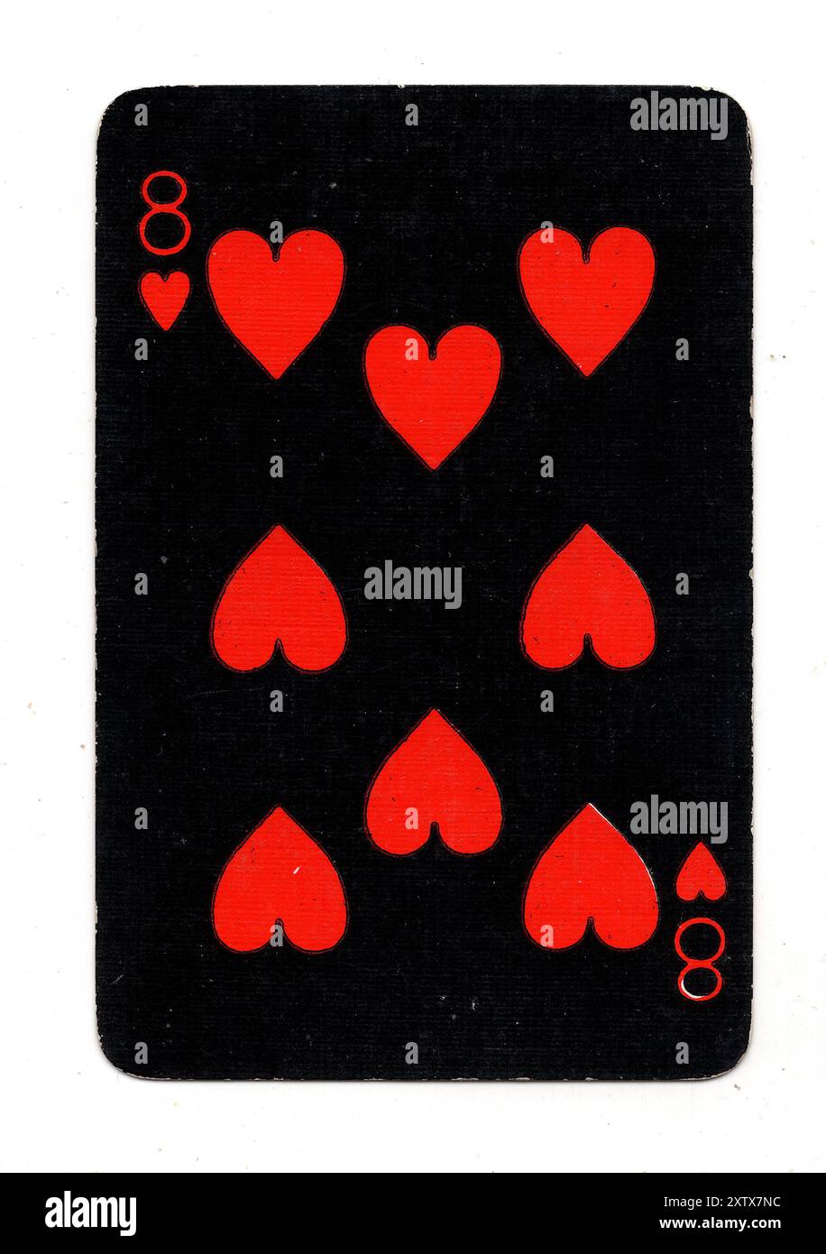 A vintage black eight of hearts playing card isolated on a white ...