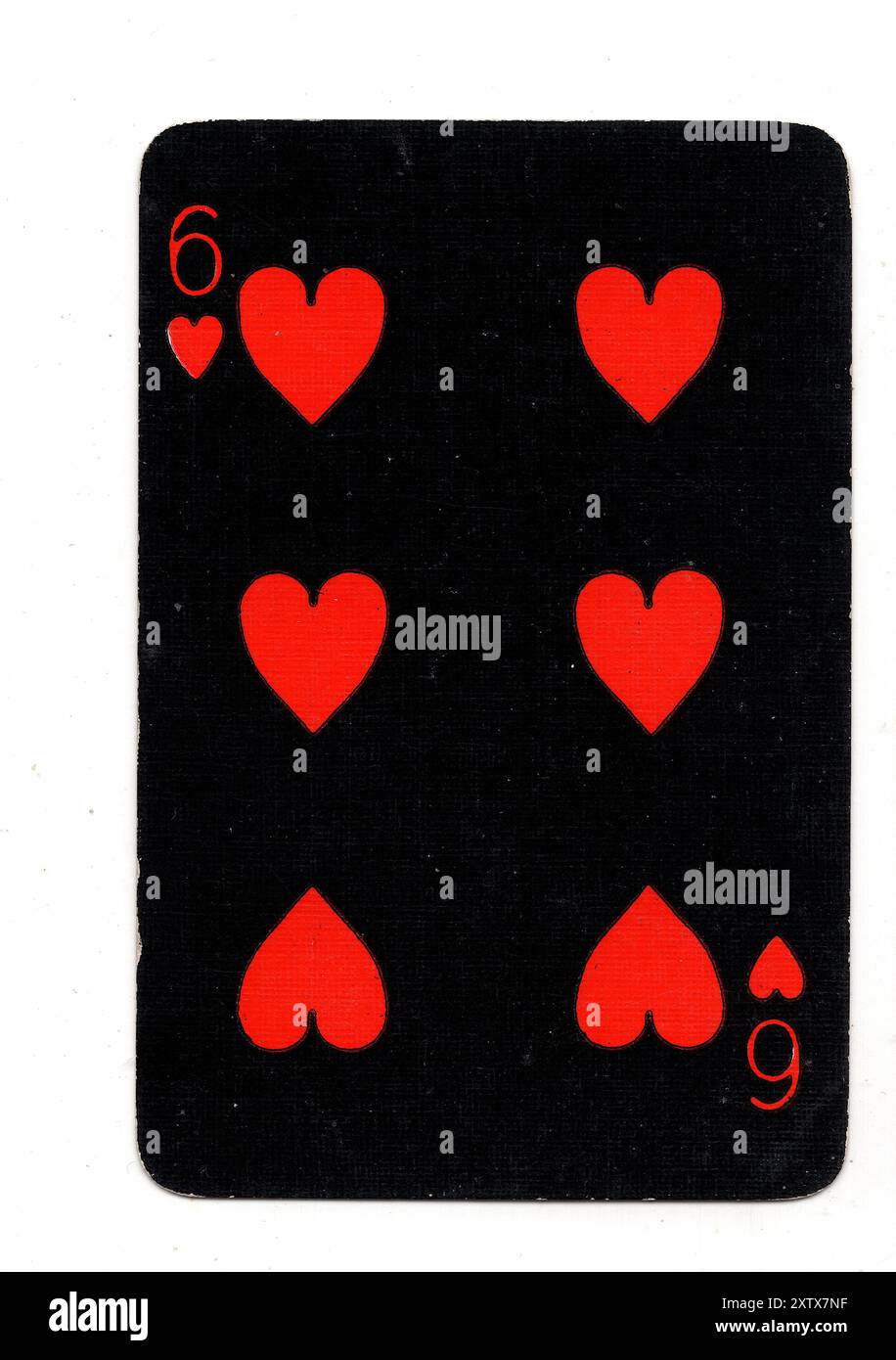 A vintage black six of hearts playing card isolated on a white ...