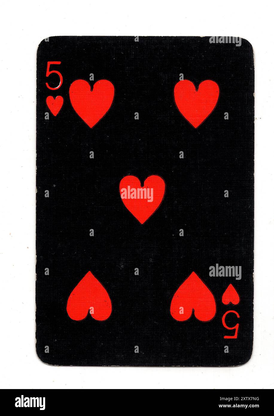 A vintage black five of hearts playing card isolated on a white ...