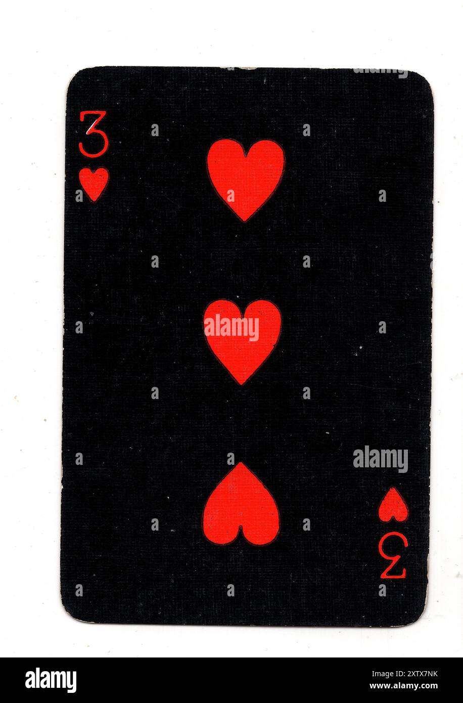 A vintage black three of hearts playing card isolated on a white ...