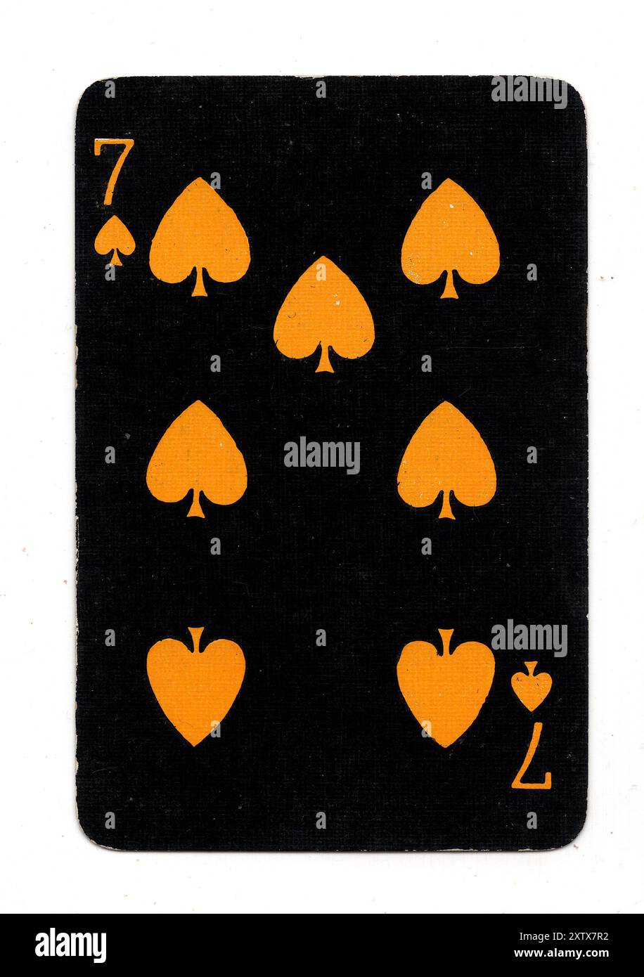 A vintage black seven of spades playing card isolated on a white ...