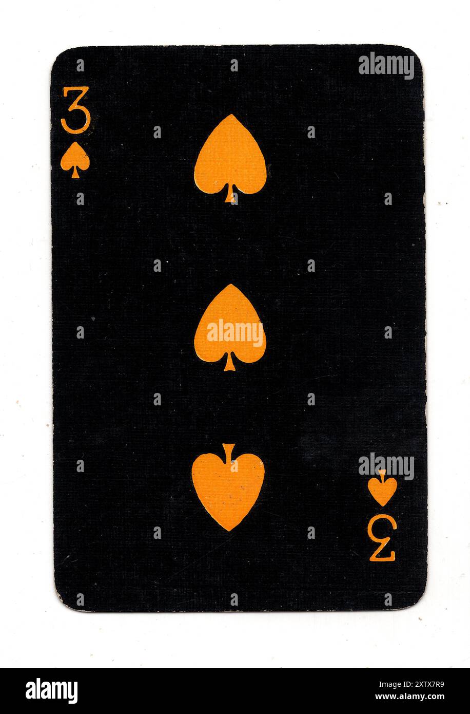 A vintage black three of spades playing card isolated on a white ...