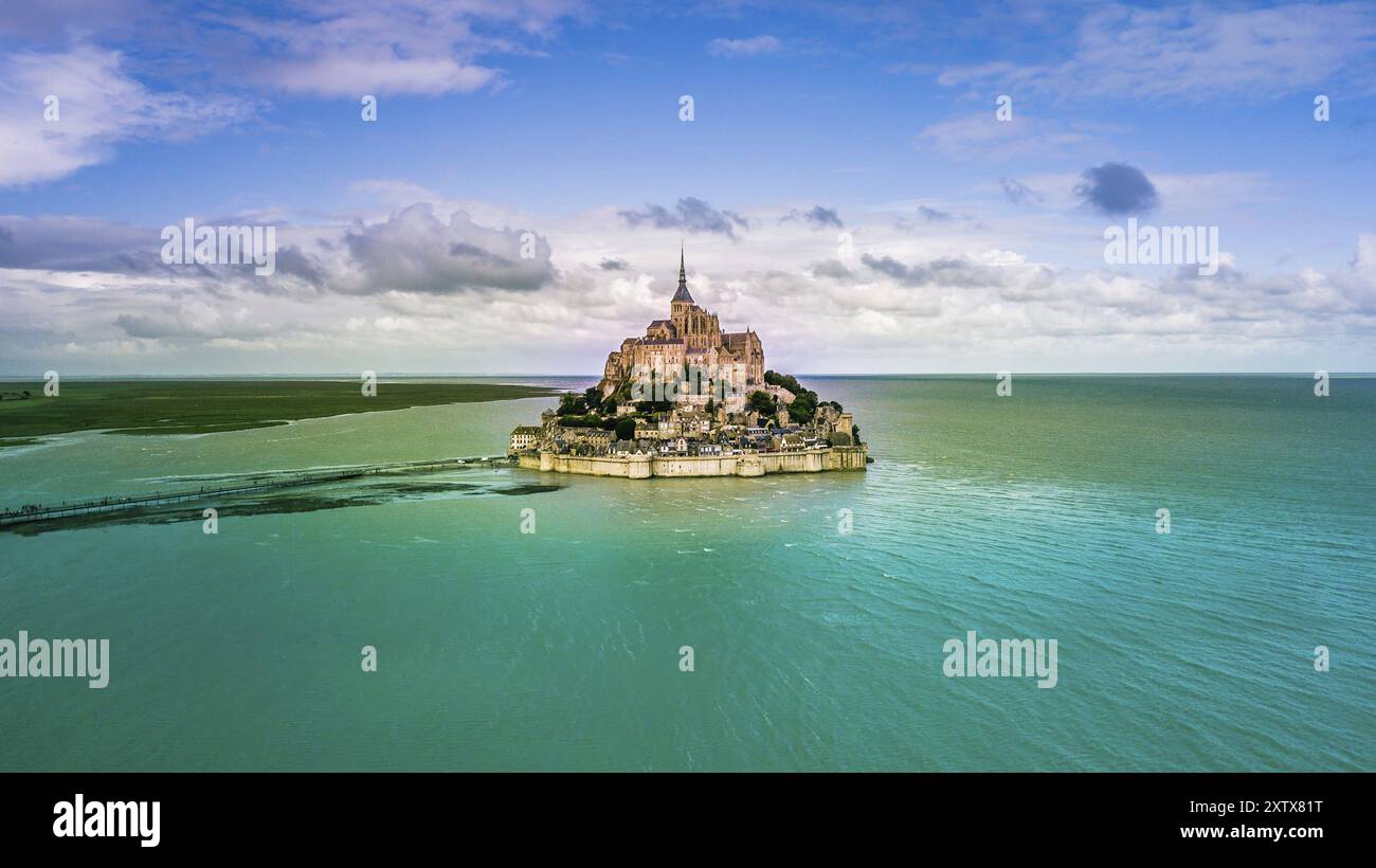 Le Mont Saint-Michel tidal island with deep blue water in golden ...