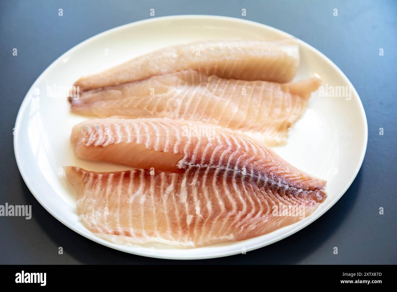 Fillet of tilapia or Saint Peter fish Oreochromis niloticus. Isolated ...