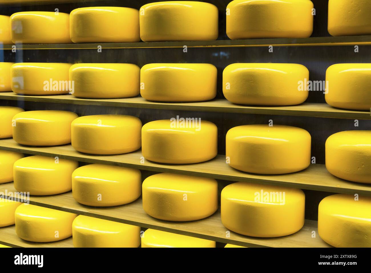 Round cheese heads in a shop window Stock Photo - Alamy