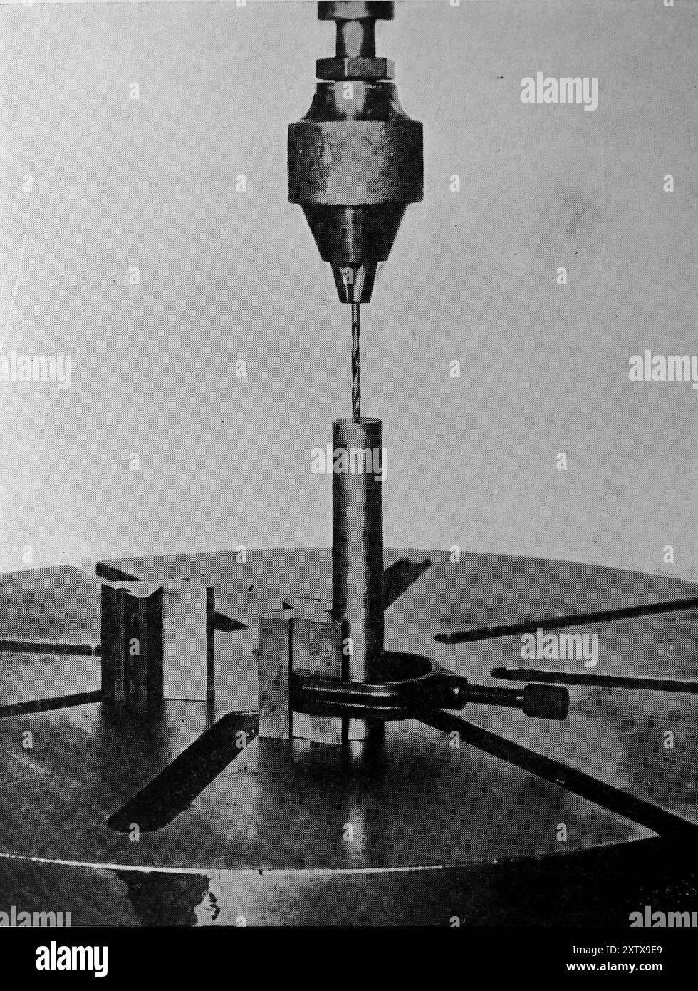 A Vee-block clamp used for drilling the ends of round objects. This ...