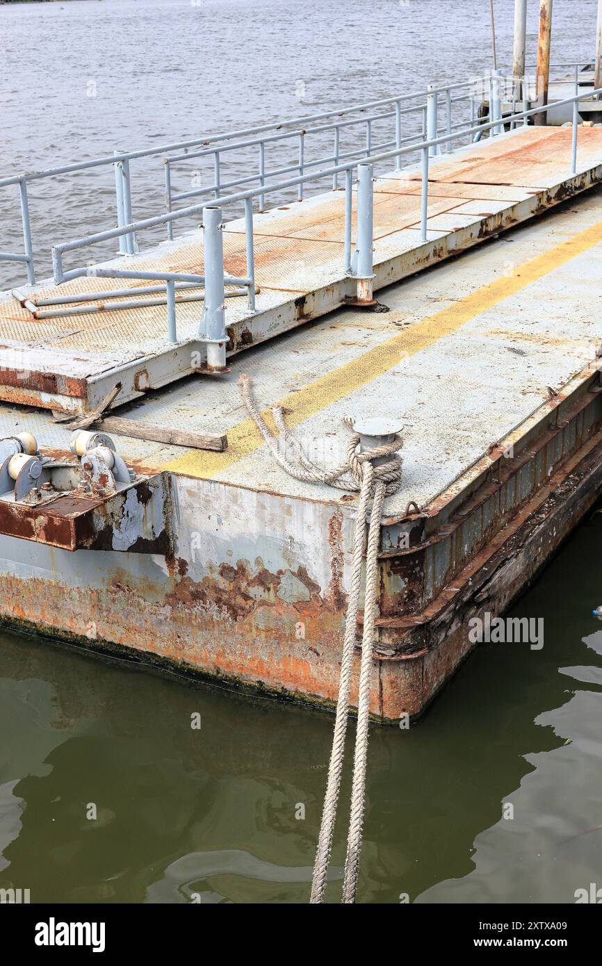 Bollard with Mooring line on rusty pier referred to a post on a ship or ...