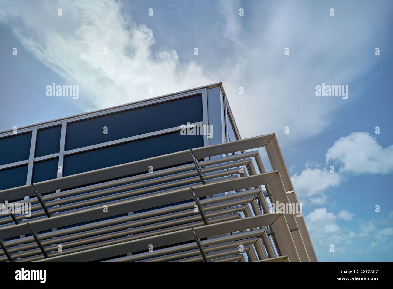 Contemporary metal building facade with sunscreens set against bright ...