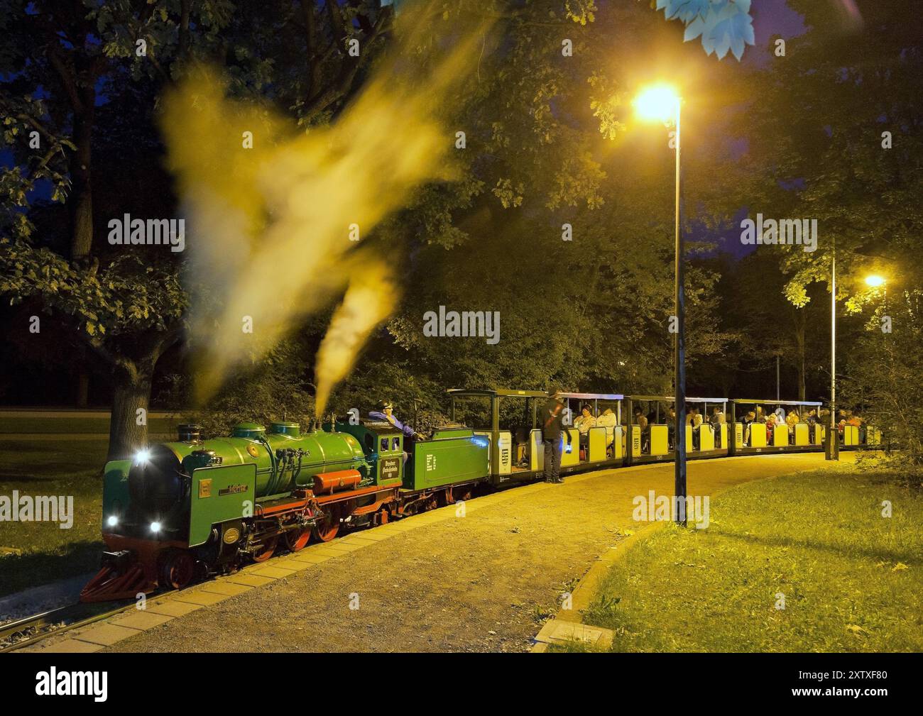 Night ride on the park railway for the long night Stock Photo - Alamy