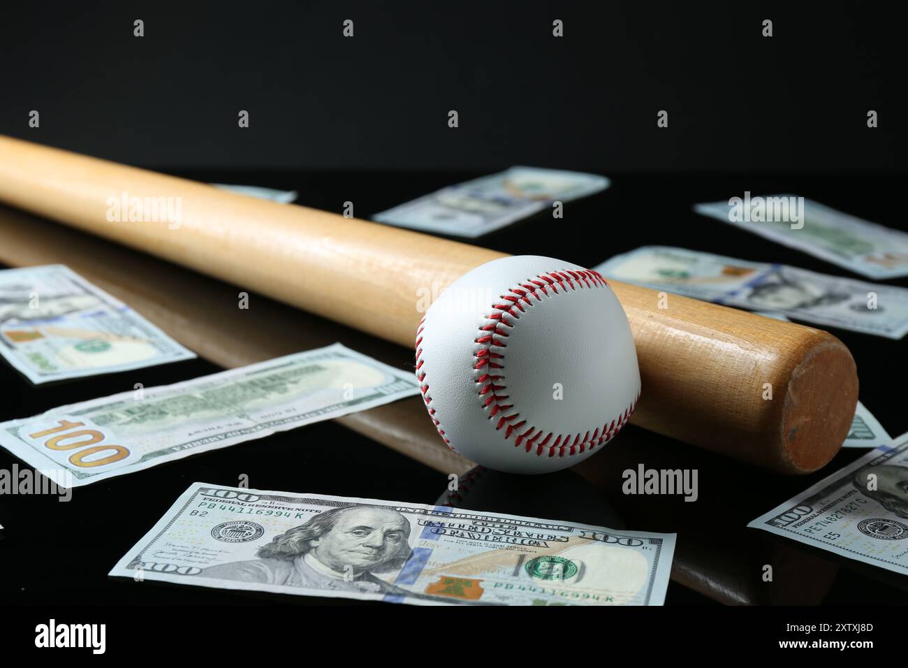 Baseball ball, bat and dollar banknotes on black background Stock Photo ...
