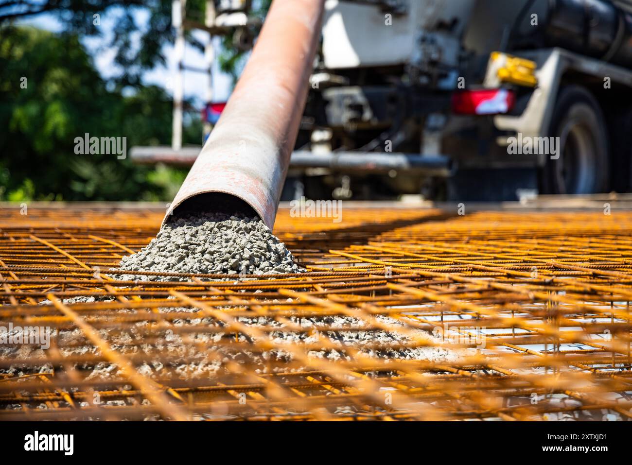 Concrete Being Poured onto Rebar Framework for Ground Slab Construction ...
