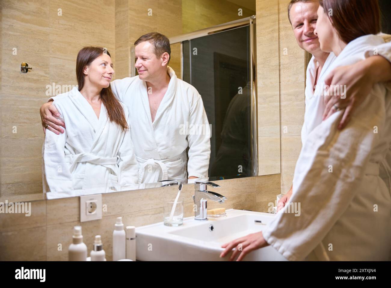 Couple are standing hugging each other in the bathroom Stock Photo - Alamy