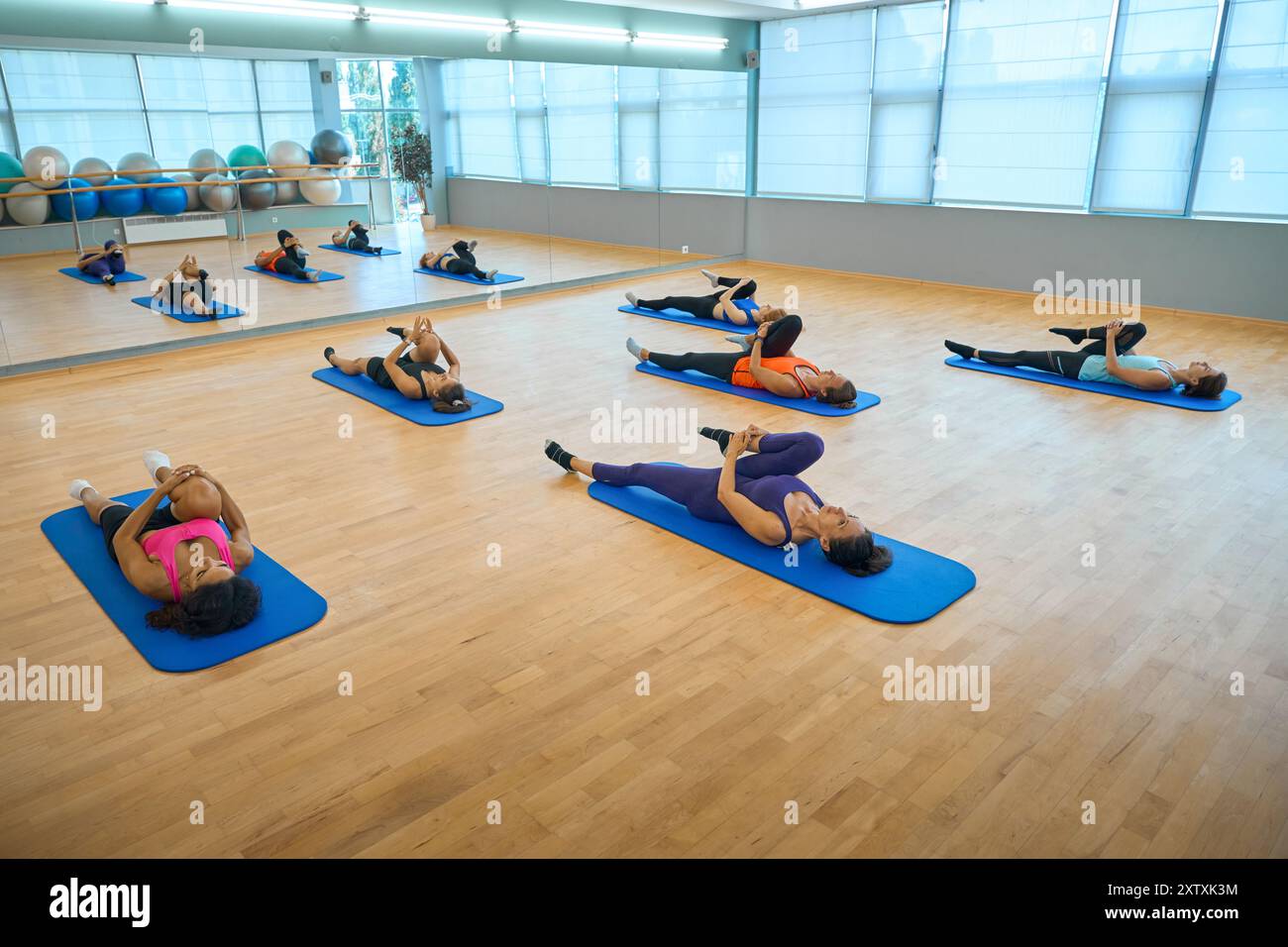 Women perform stretching exercises on the floor Stock Photo - Alamy