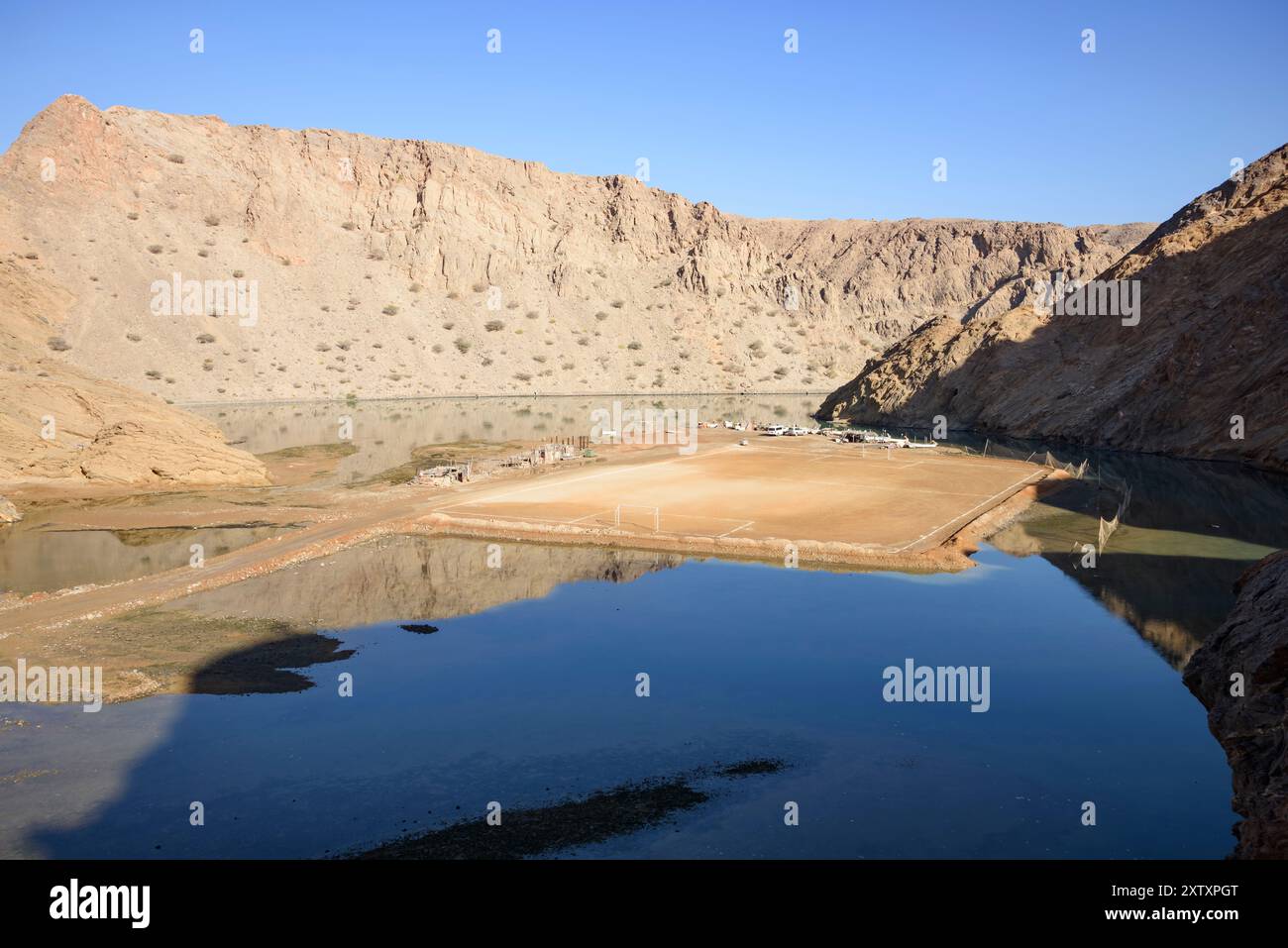 Football field and pier by the sea in Bandar Khairan, Muscat, Oman ...