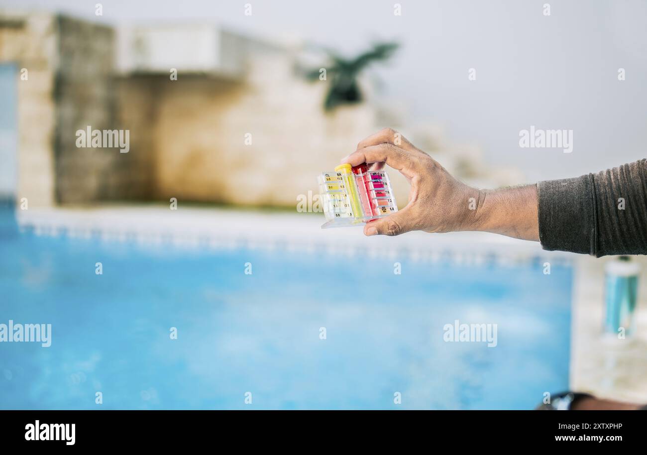 Hand showing tester kit to measure chlorine and ph in swimming pools ...