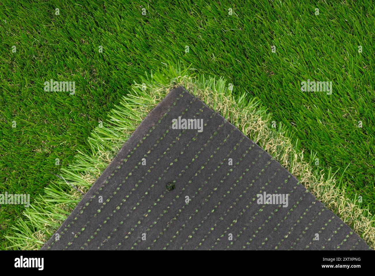 Unrolled Artificial Grass Roll on Lawn Stock Photo - Alamy