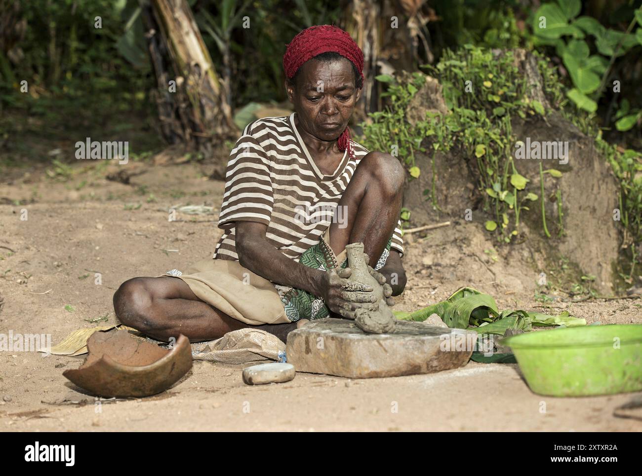 Woman from the Ari ethnic group making pottery on a pottery slab ...
