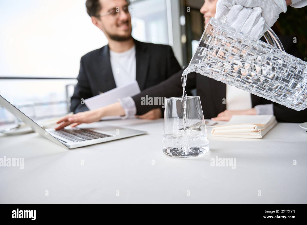 Male waiter pouring water hi-res stock photography and images - Alamy