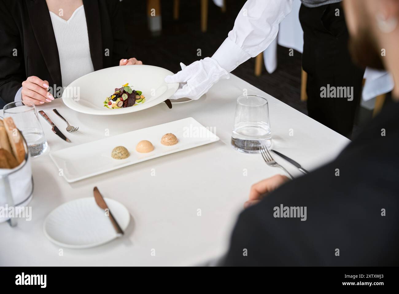 Female waiter putting food on hi-res stock photography and images - Alamy