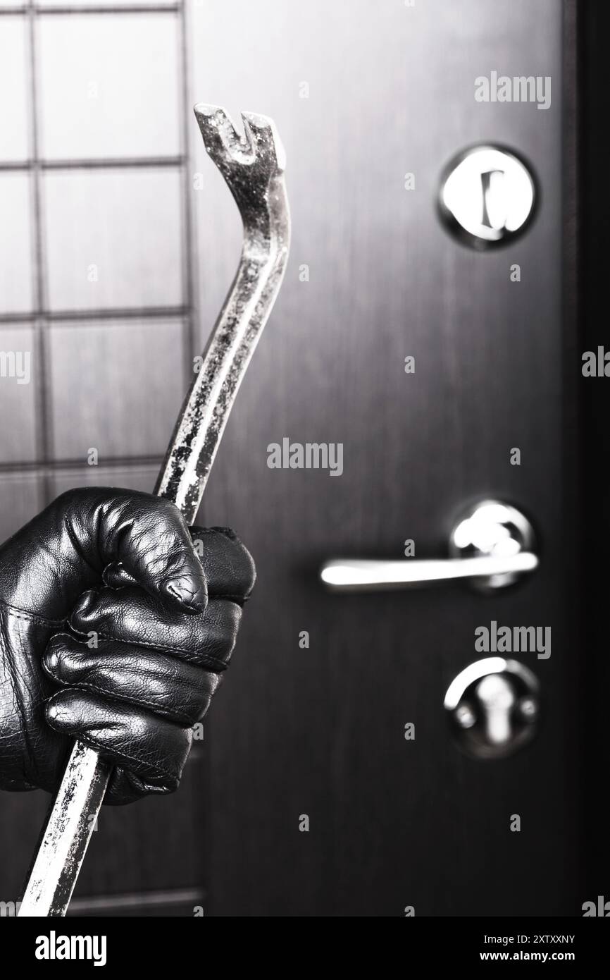 Crime scene, criminal thief or burglar hand in gloves holding metal ...
