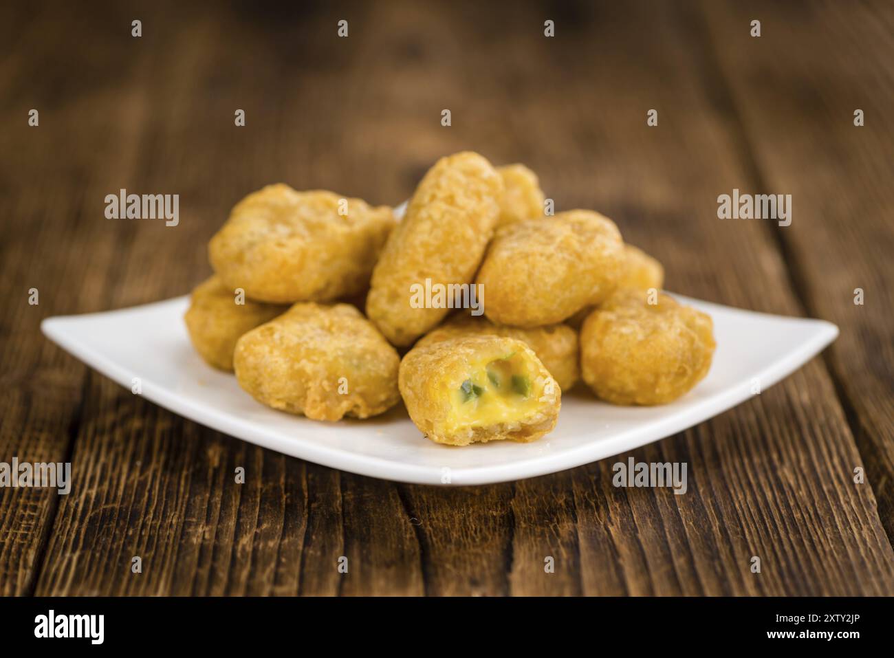 Chili Cheese Nuggets on a vintage background as detailed close-up shot ...