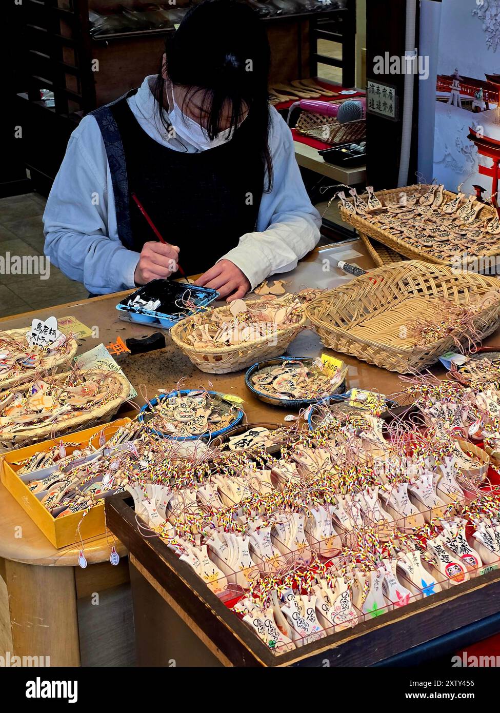 Local craftsperson painting on wooden artefacts in Hiroshima. Crafted ...
