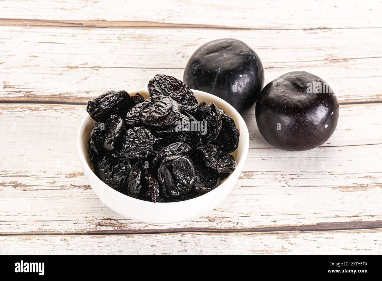 Dry sweet prunes in thw bowl Stock Photo - Alamy