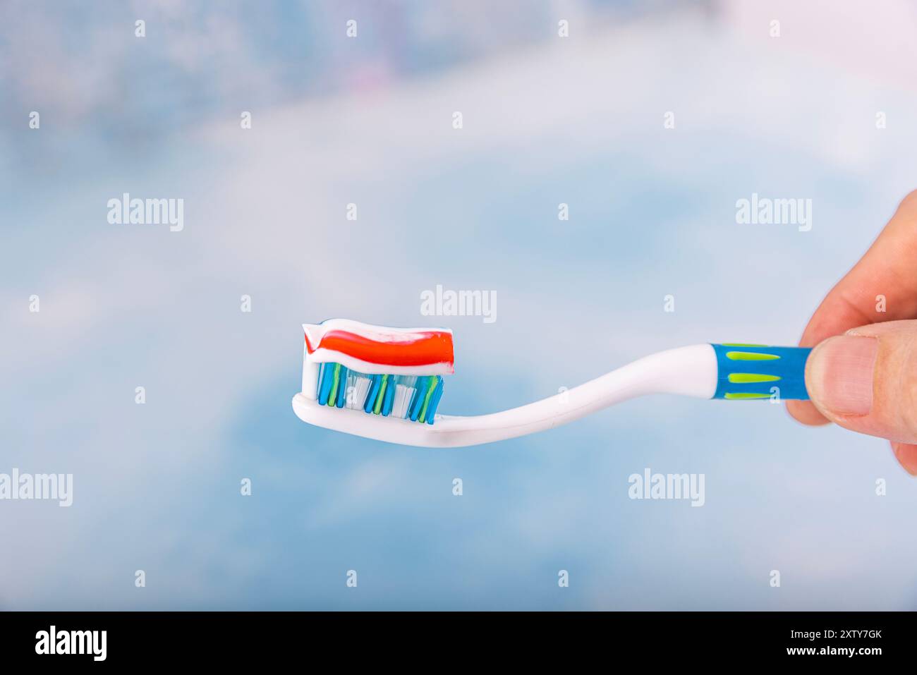 Toothpaste squeezed from tube onto brush, close up. Toothpaste being ...