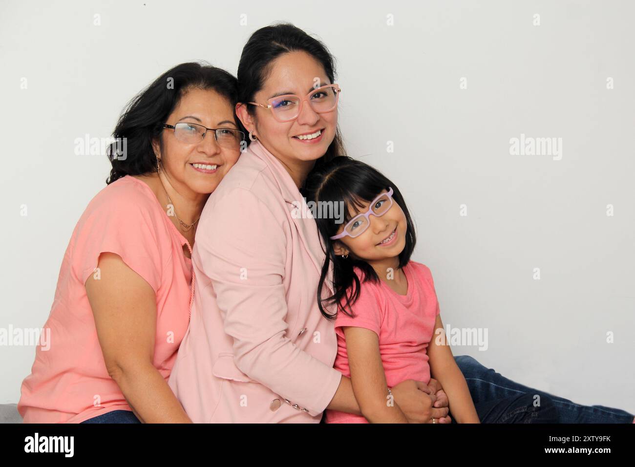 Three generations of brunette Latina women, grandmother, mom and ...