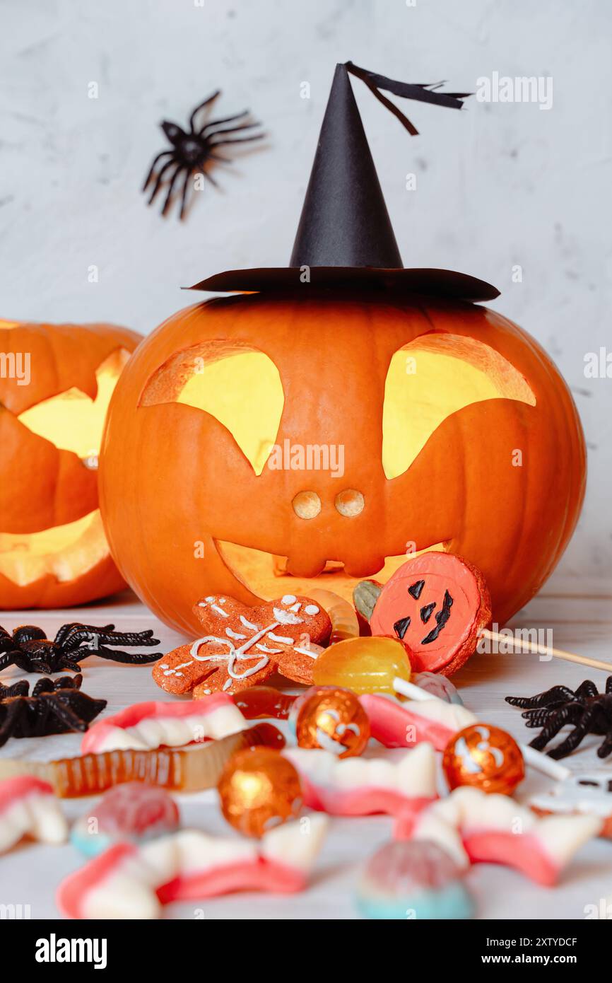Friendly looking Halloween carved glowing pumpkin throw up candy ...