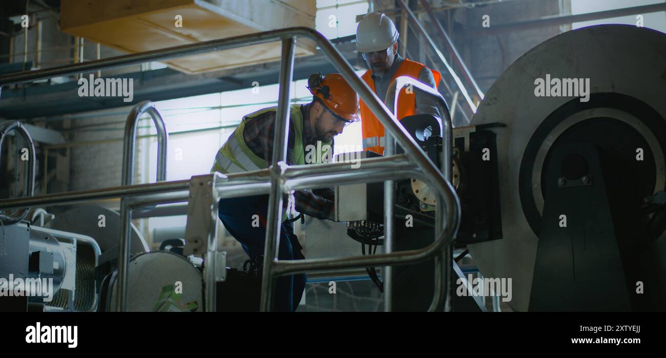 Worker in helmet talks shows hi-res stock photography and images - Alamy