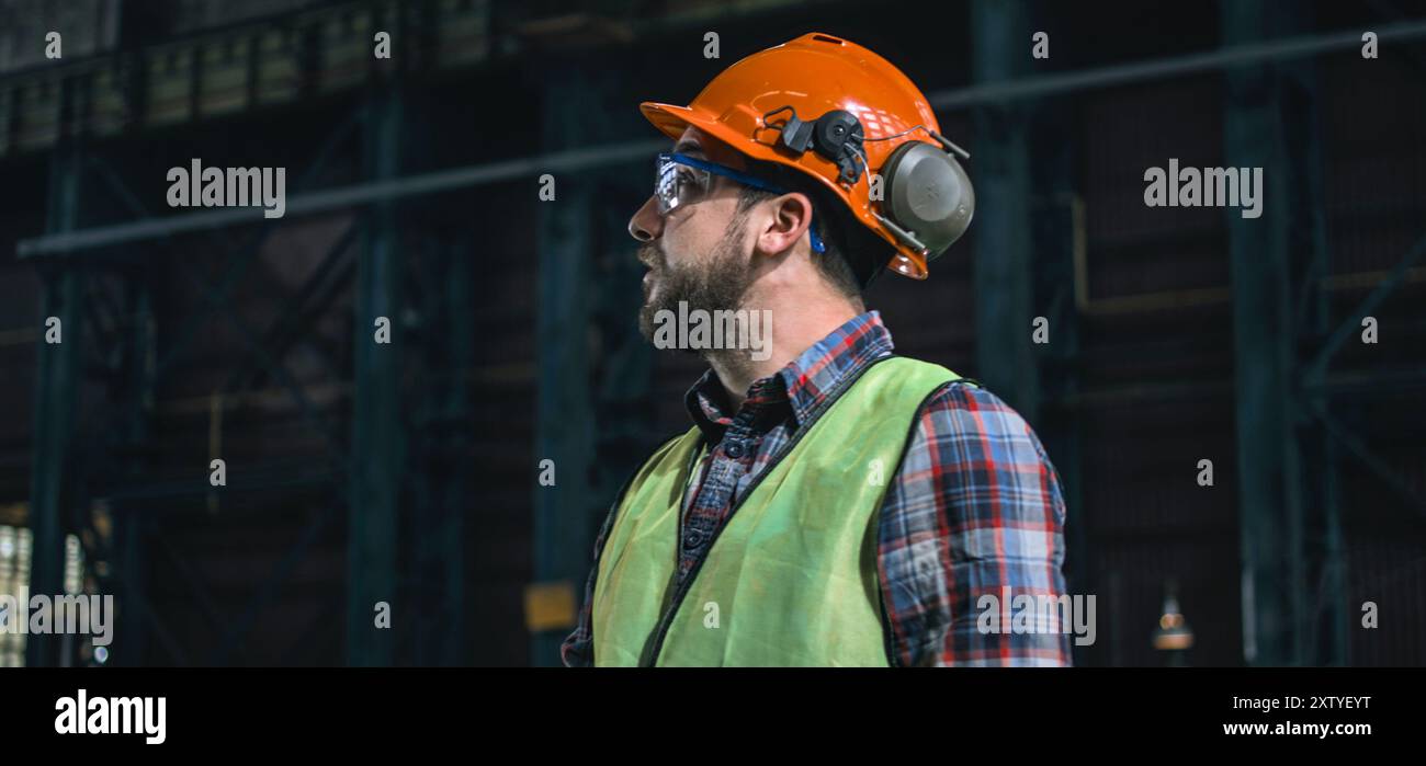 Professional heavy industry engineer in safety uniform and hard hat at ...