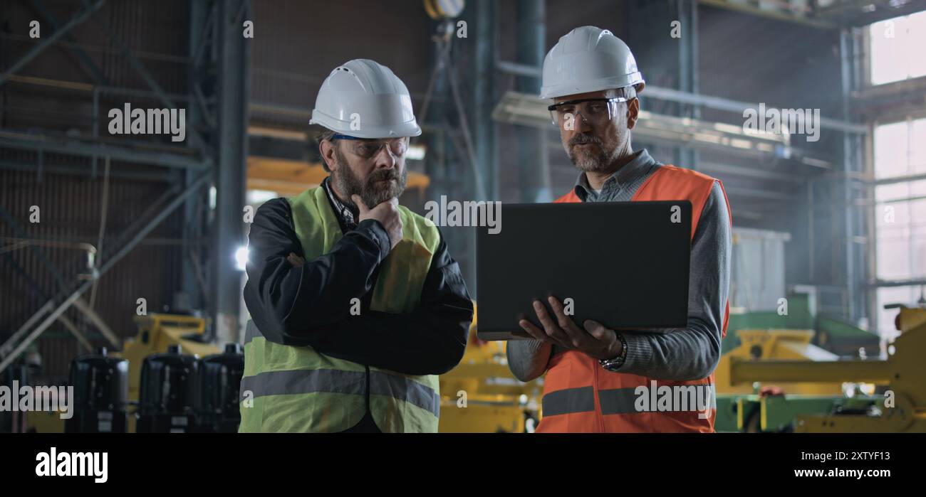 Engineers in factory warehouse two hi-res stock photography and images ...