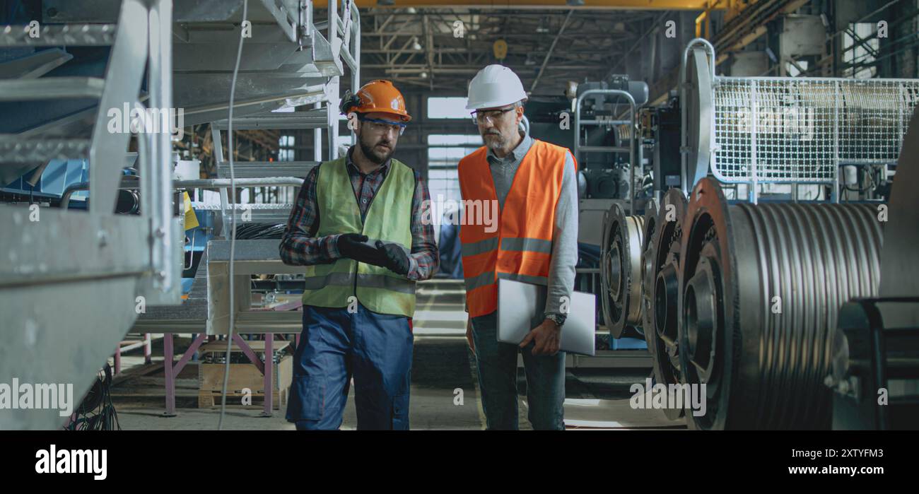 Factory engineers walking production facility hi-res stock photography ...