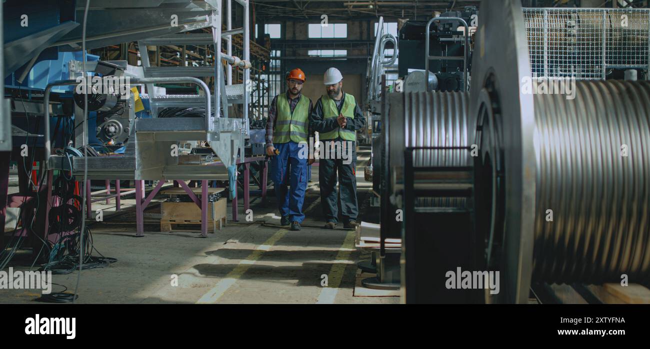 Two employees walking in factory hi-res stock photography and images ...
