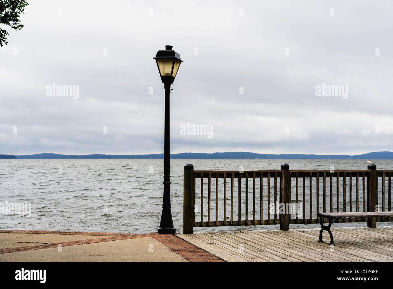 Waterfront view walkway with lamp post, Scenic walkway, overcast grey ...