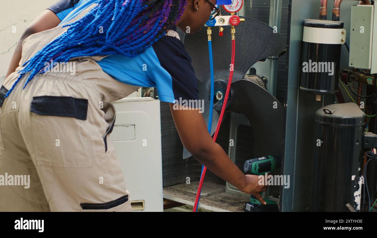 Portrait of happy technician starting work on busted air conditioner ...