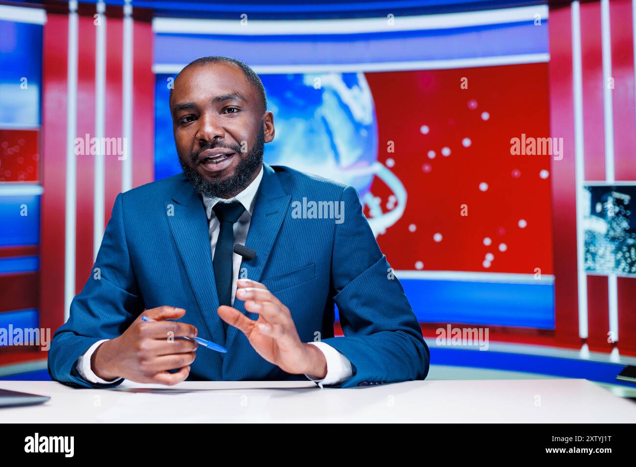 Presenter broadcasting tv content from media studio, reading headlines ...