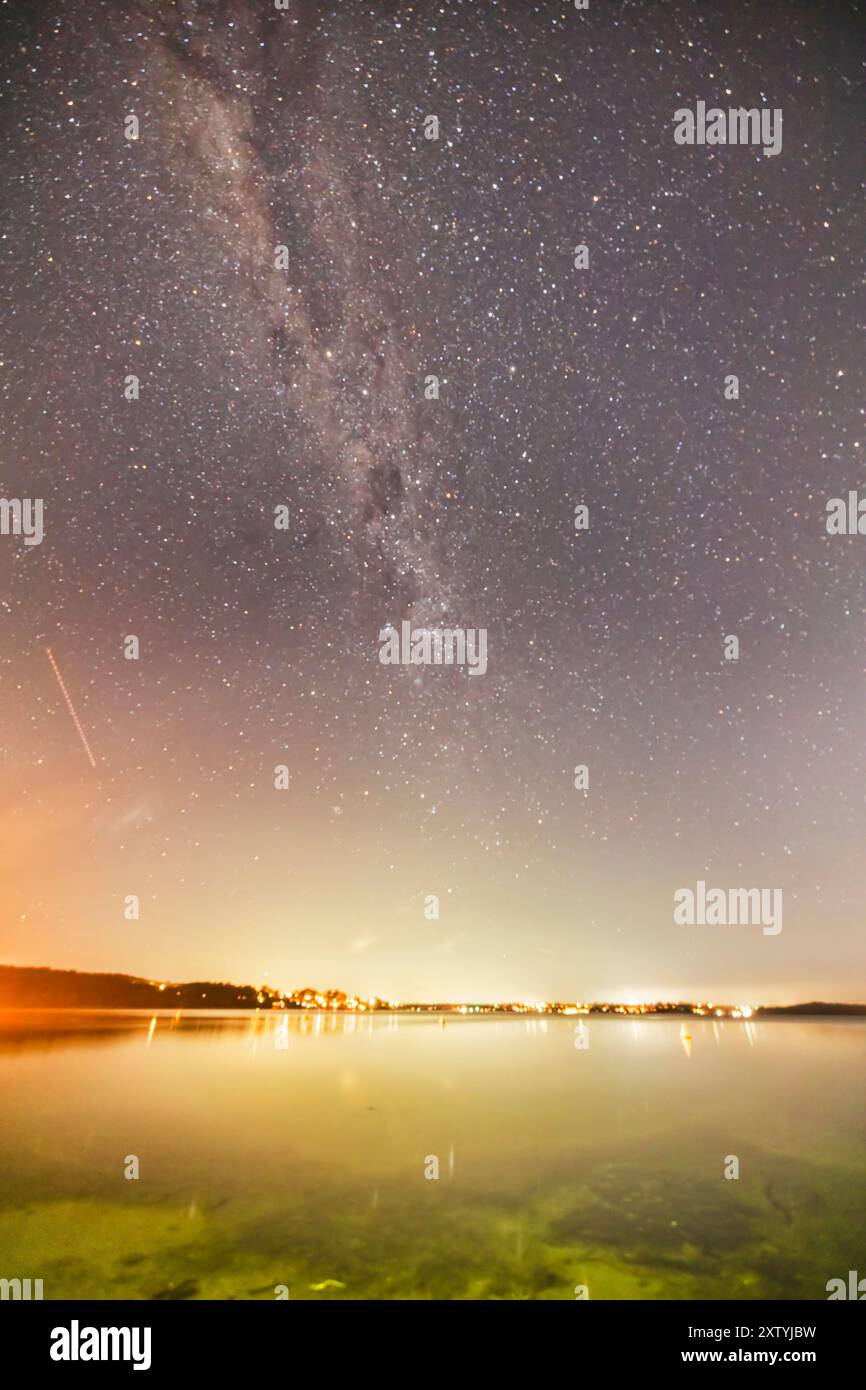 Waterfront of Lake Macquarie reflecting starry night Milky Way galaxy ...