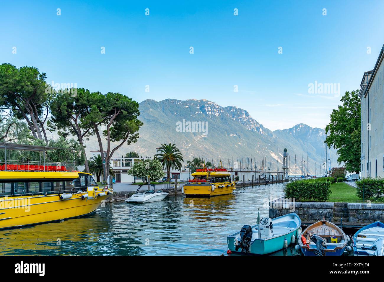 small tourist port with two yellow ferries anchored in the waters of ...
