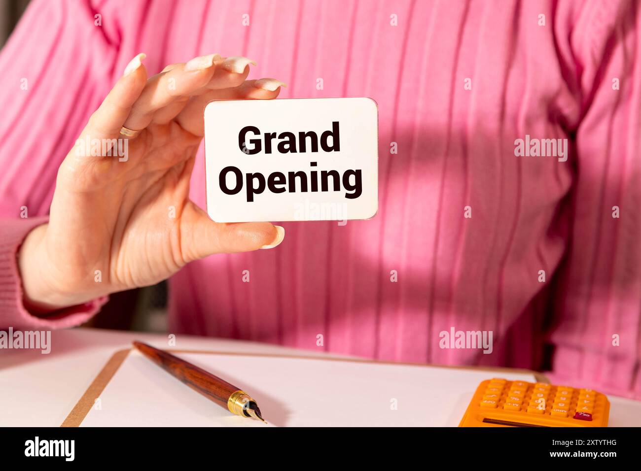 Text message GRAND OPENING on brown torn paper with black backdrop ...