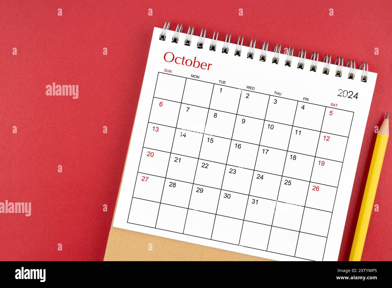 October 2024 desk calendar and pencil on red color background Stock ...