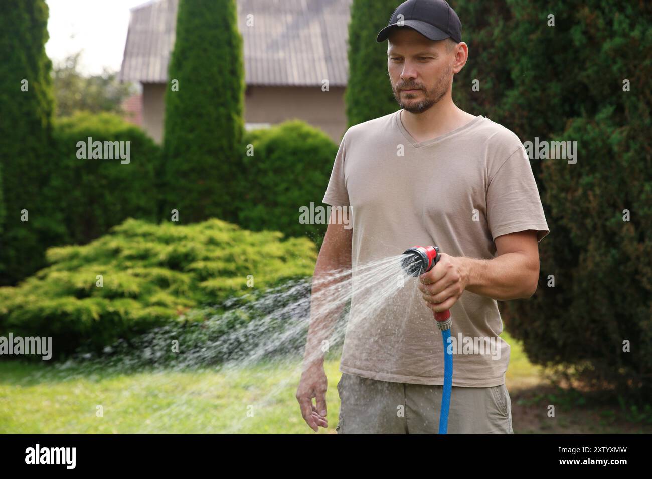 Person watering the lawn hi-res stock photography and images - Alamy