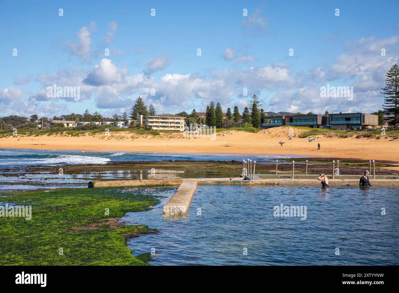 Mona Vale beach and its ocean rockpool with two swimmers using the pool ...