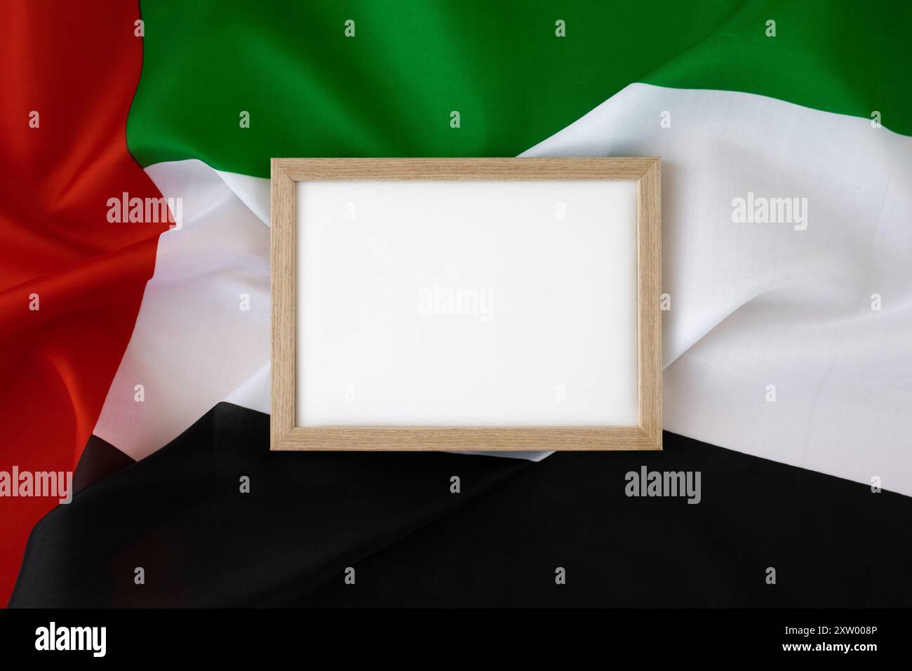 Empty white paper frame Small flag of UAE on beige background with ...