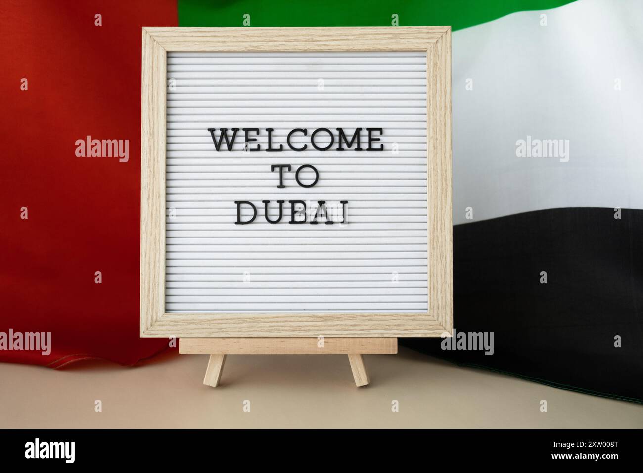 Frame text WELCOME TO DUBAI on background of waving UAE flag made from ...