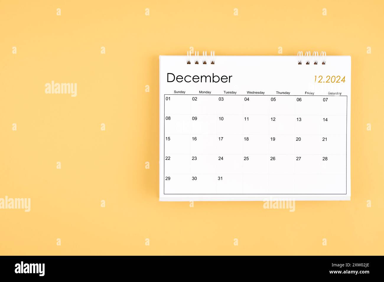 December 2024 desk calendar on yellow color background, position with ...