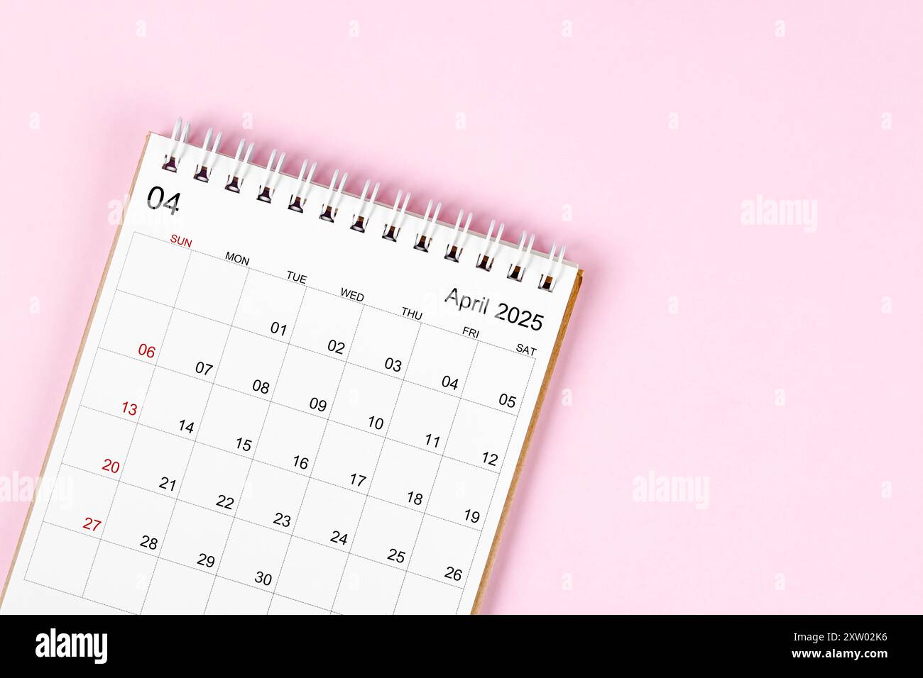 April 2025 desk calendar on pink color background, Position with empty ...