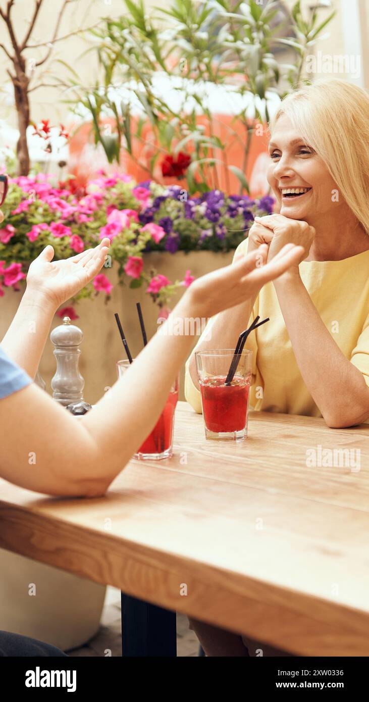 Engaging and Joyful Conversation Over Refreshing Drinks in a Beautiful ...